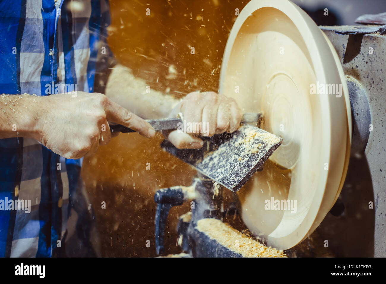 man turning a wooden plate on a lathe Stock Photo - Alamy