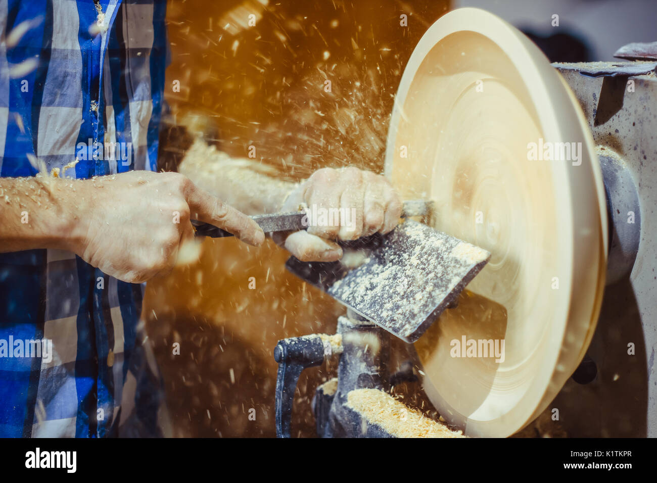 man turning a wooden plate on a lathe Stock Photo - Alamy