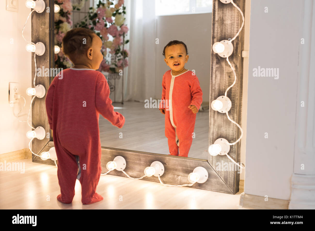 Cute curious baby study things in the room Stock Photo - Alamy