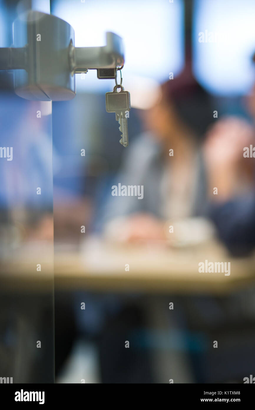 Open glass door with keys, key in keyhole Stock Photo - Alamy
