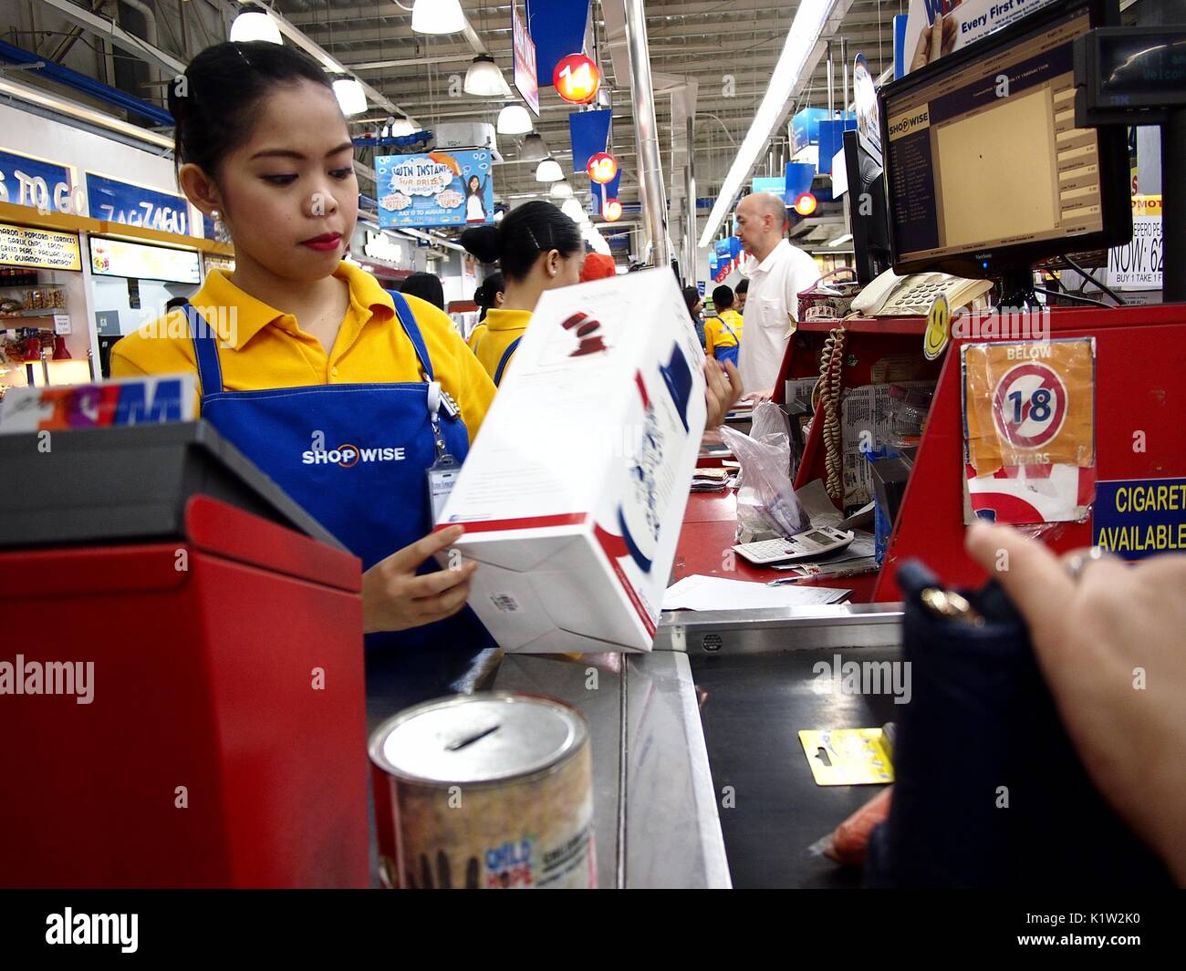 ANTIPOLO CITY, PHILIPPINES - AUGUST 23, 2017: A cashier at a grocery ...