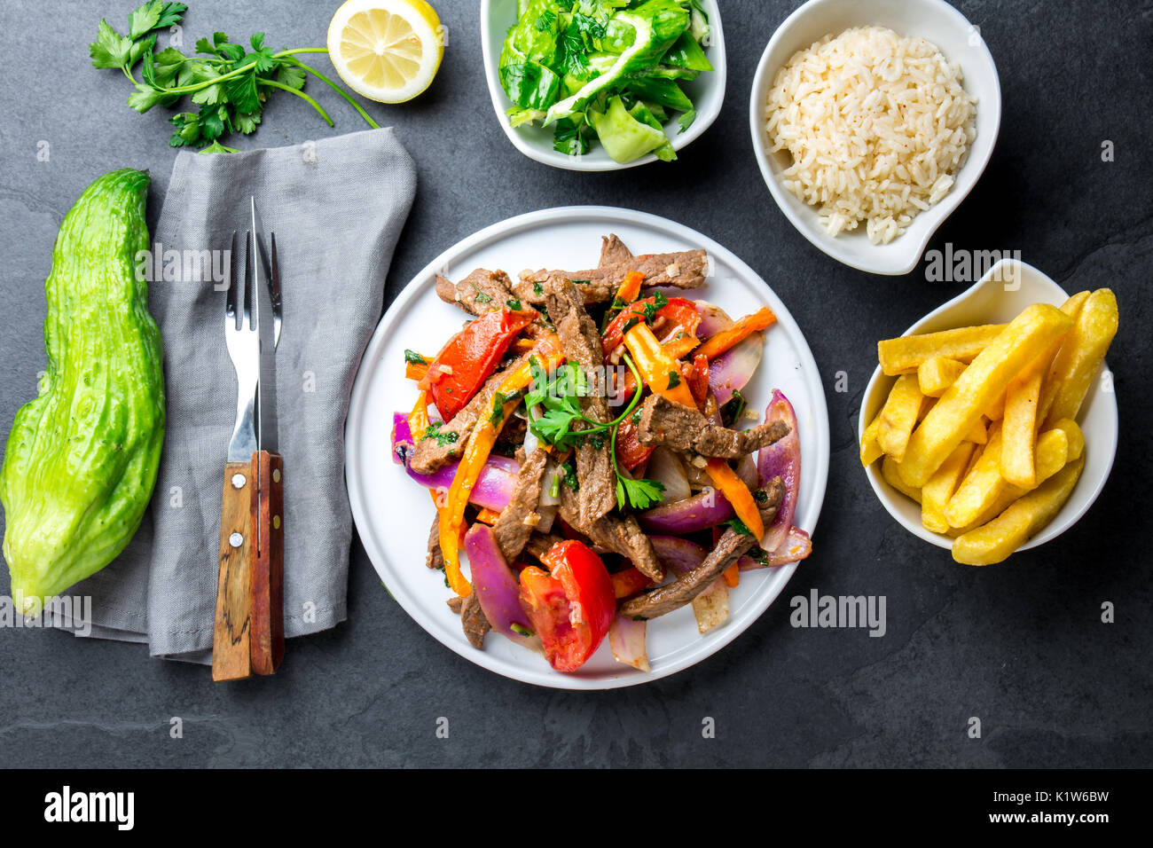 Peruvian dish Lomo saltado - beef tenderloin with purple onion, yellow ...