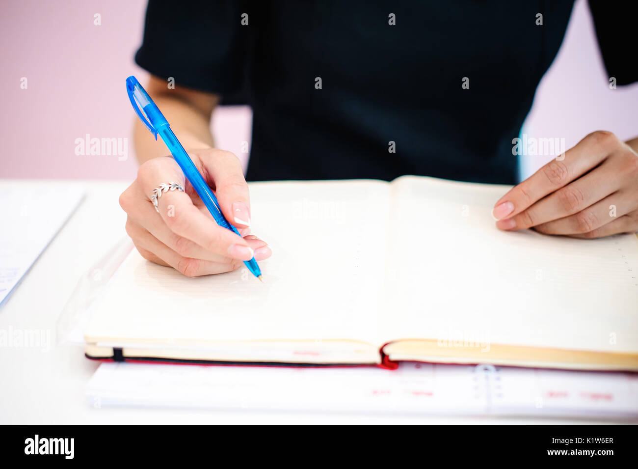 Business woman making notes in notepad. Beautiful well-groomed hands ...