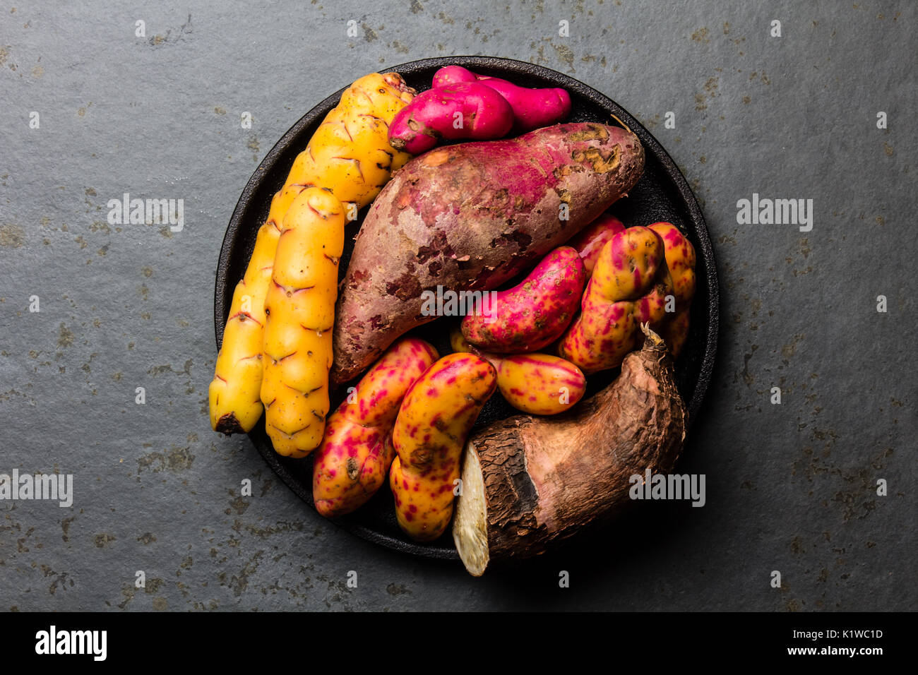 Peruvian raw ingredients for cooking - yuca, colored sweet potatoes and ...