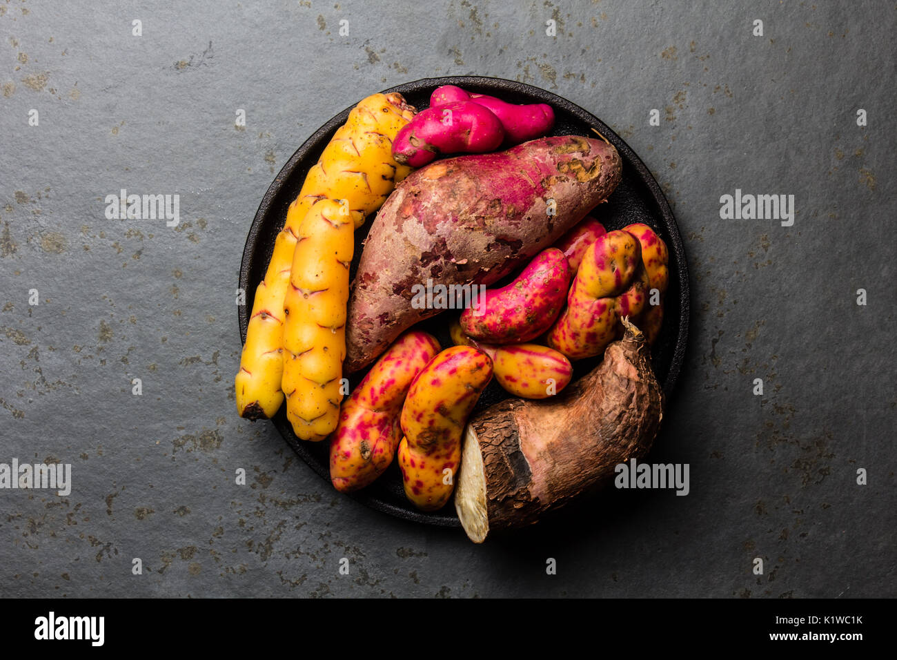 Peruvian raw ingredients for cooking - yuca, colored sweet potatoes and ...