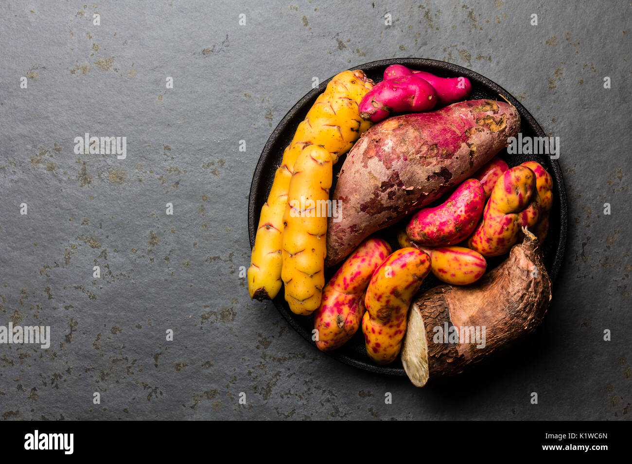 Peruvian raw ingredients for cooking - yuca, colored sweet potatoes and ...