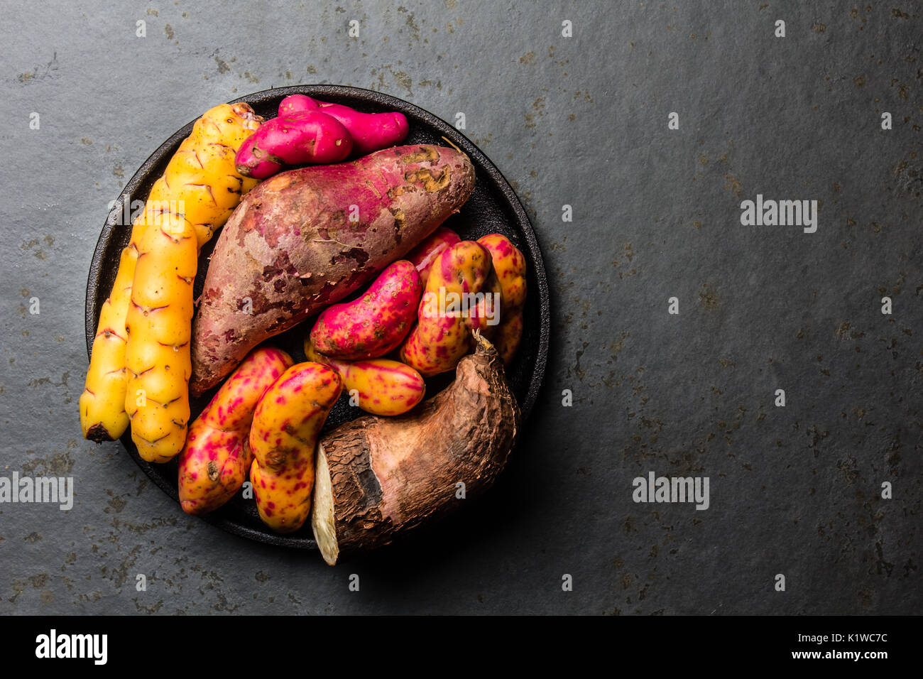 Peruvian raw ingredients for cooking - yuca, colored sweet potatoes and ...