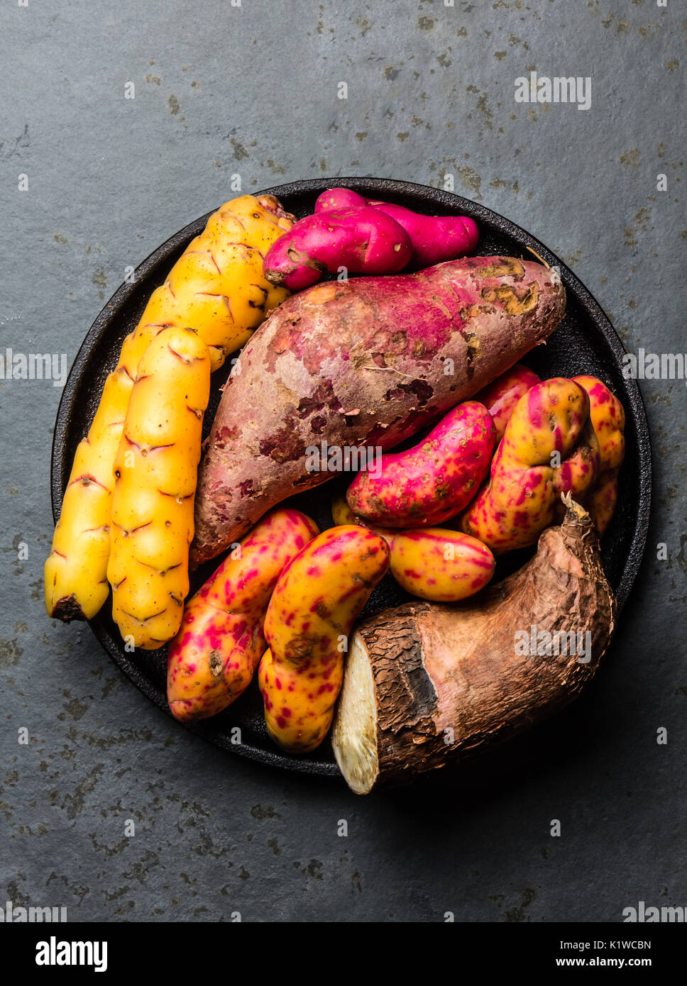 Peruvian raw ingredients for cooking - yuca, colored sweet potatoes and ...