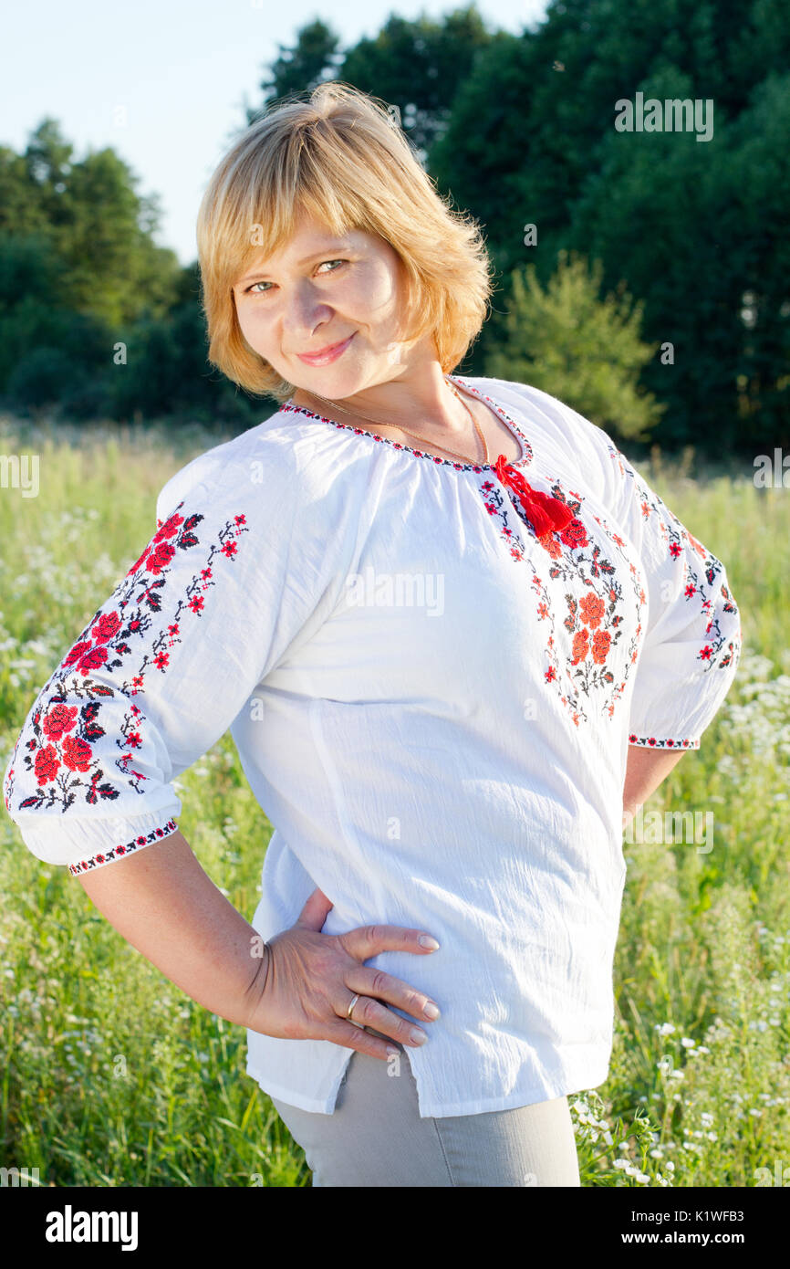Happy woman smiling in the nature background Stock Photo - Alamy