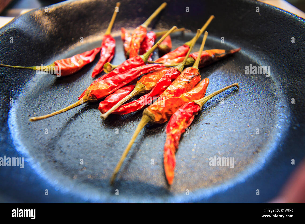 The Red hot natural chili pepper pod realistic image on the black disk ...