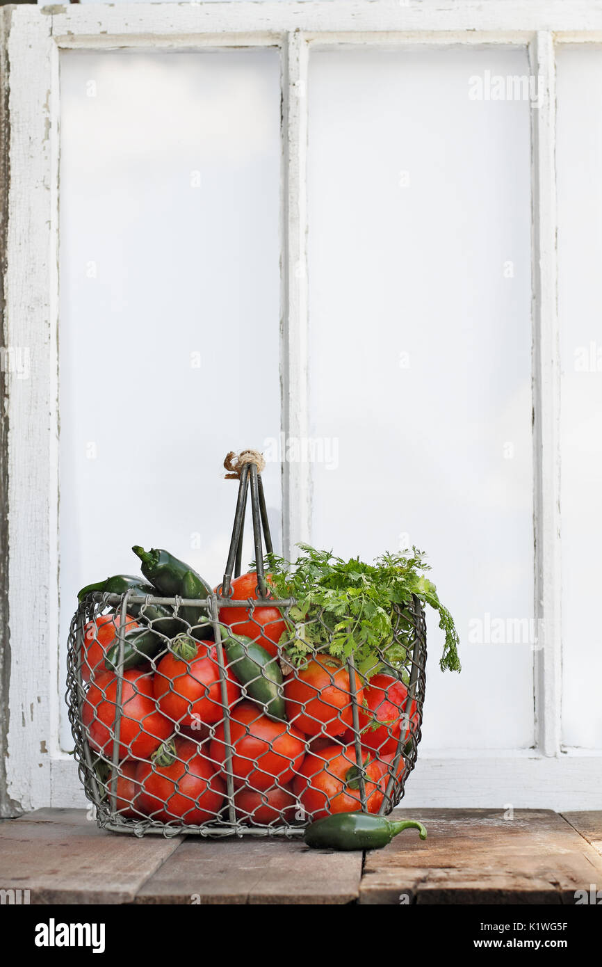 Ingredients for homemade salsa in an old country basket sitting in ...