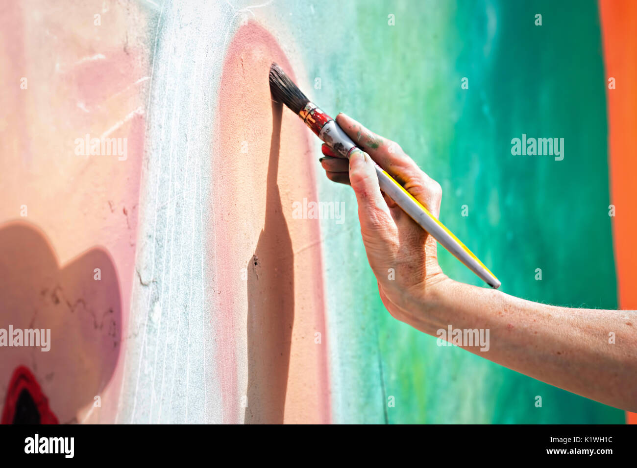 Hand of artist painting with brush portrait= Stock Photo - Alamy
