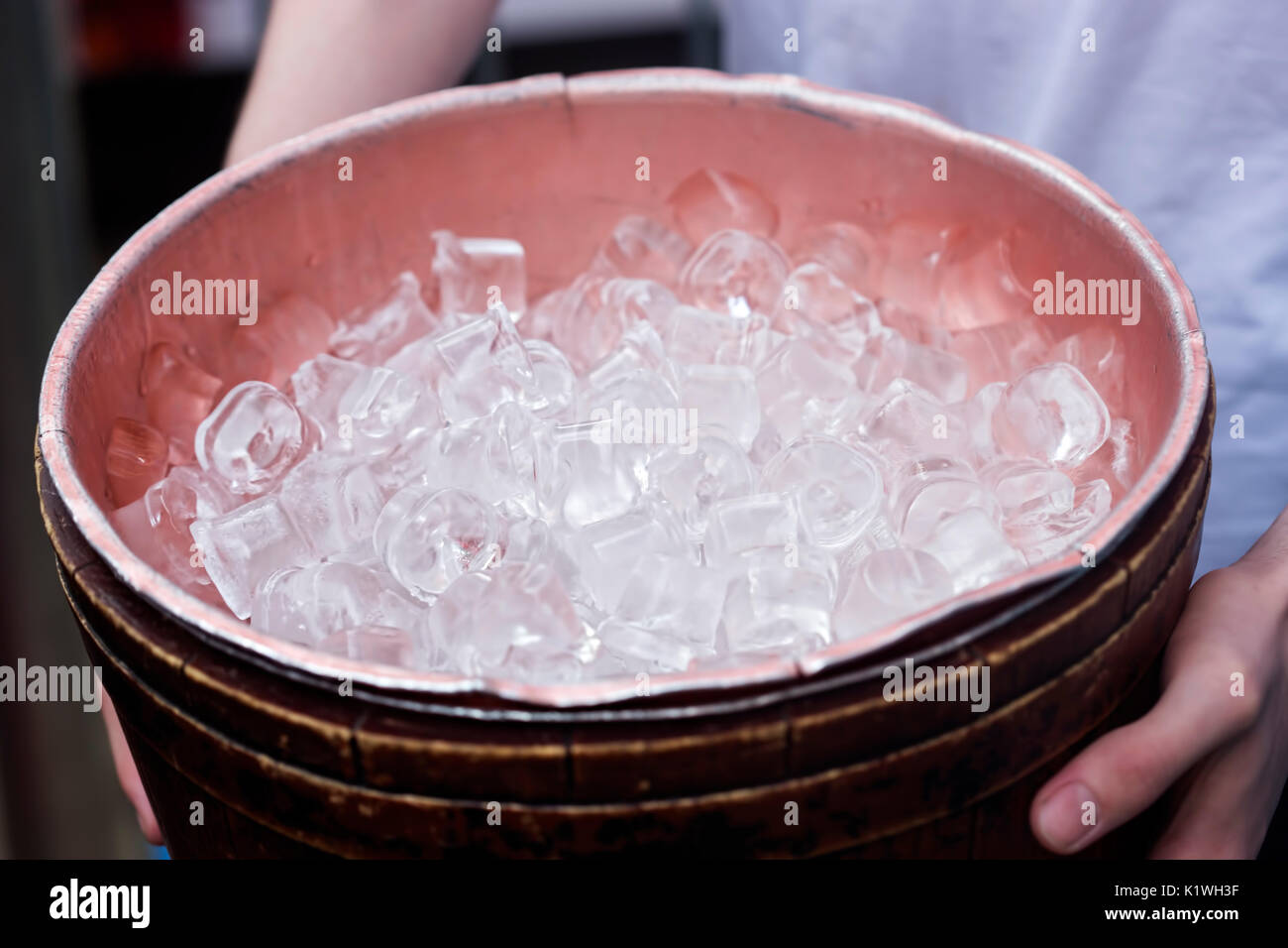 Male holding container with ice cubes Stock Photo - Alamy