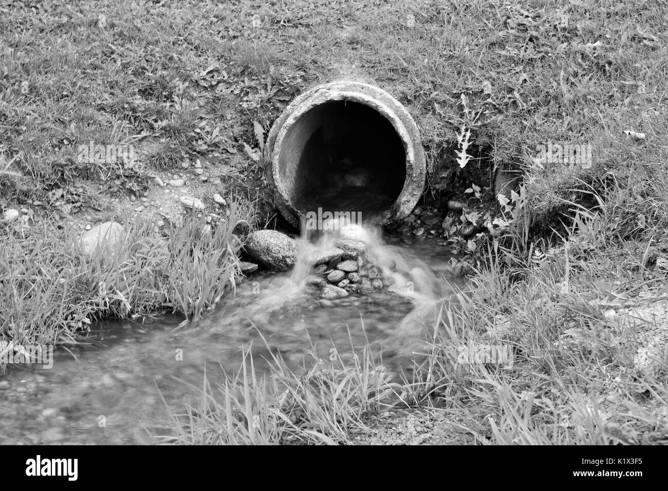 Small Waterfall from Drain Pipe at Kiwanis Park in black and white ...