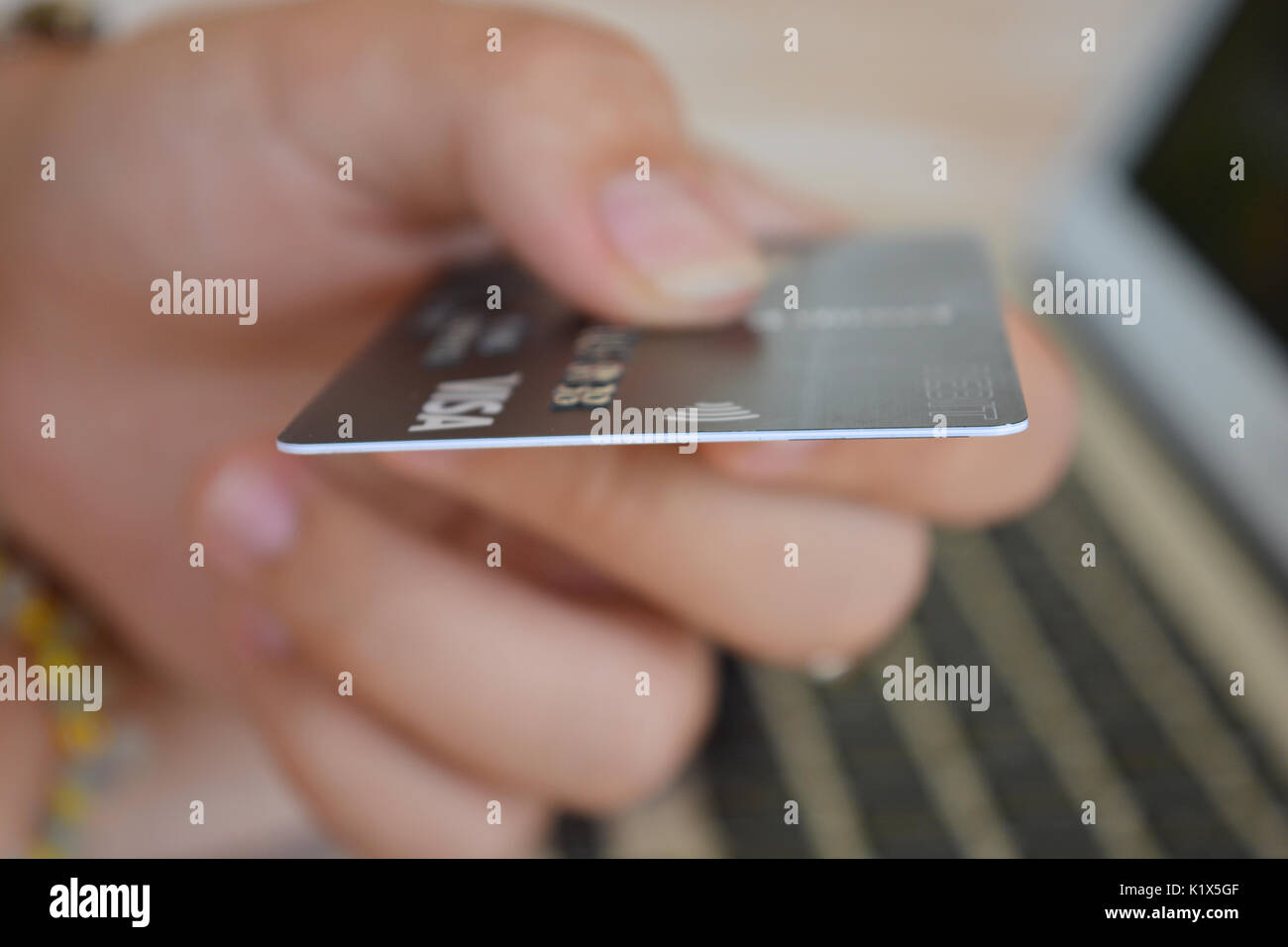 Using a visa debit card for online shopping Stock Photo - Alamy