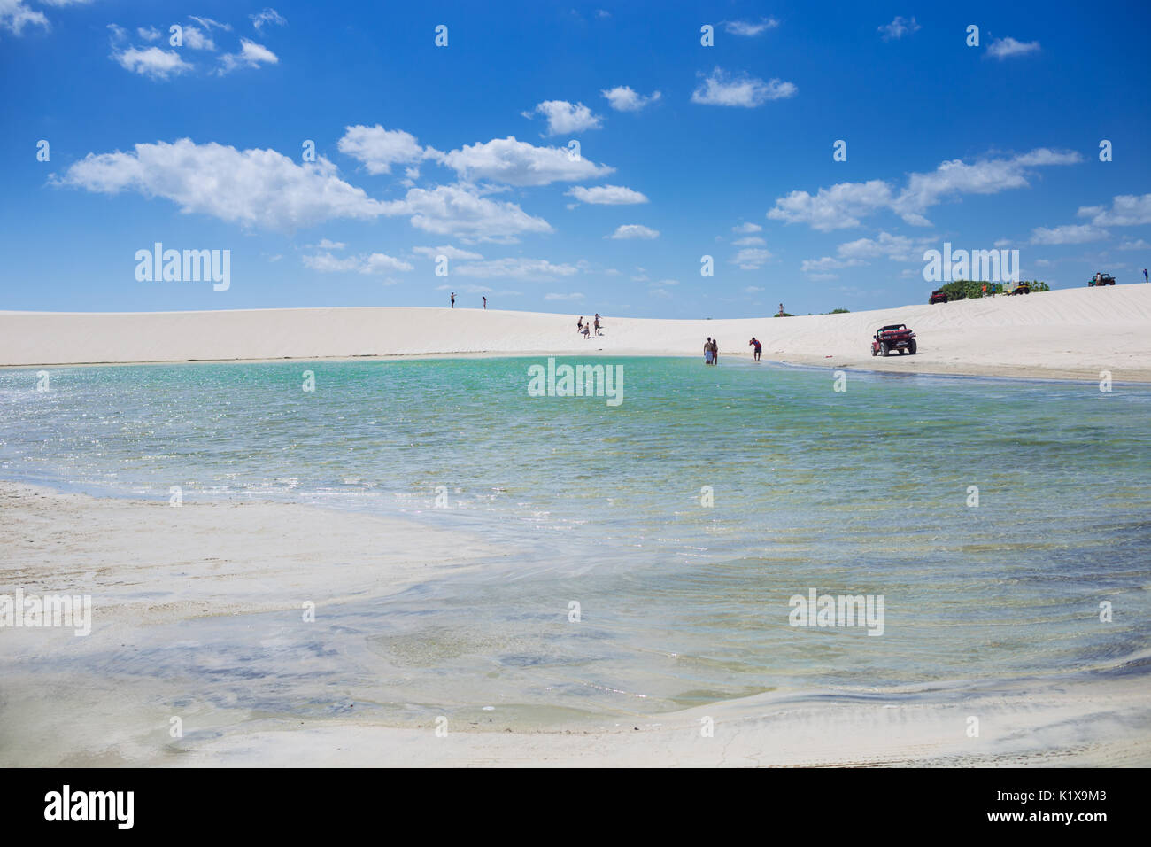 People in a tour in a natural rain lake oasis between de dunes near ...