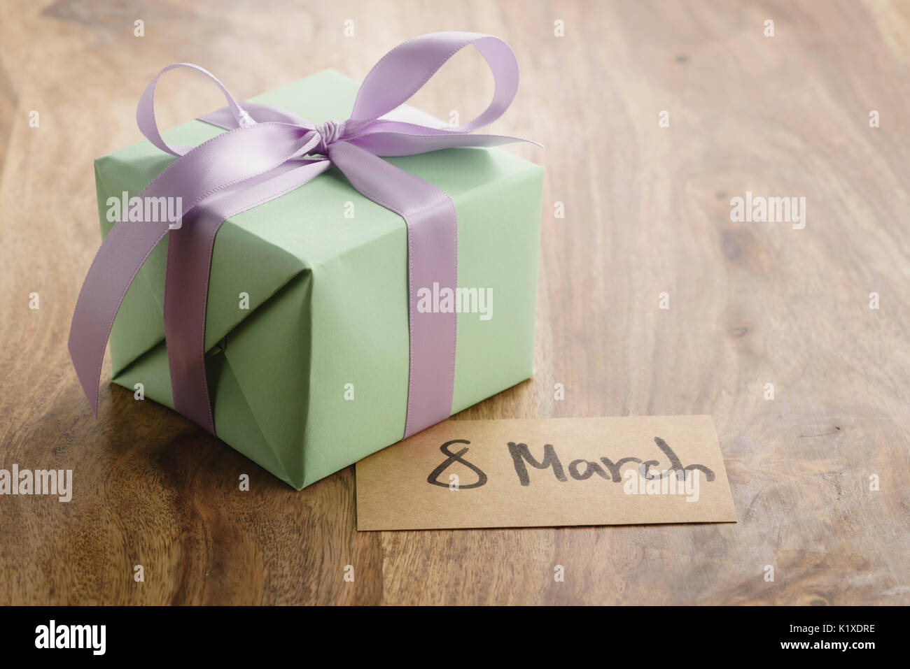 green paper gift box with purple ribbon bow and 8 march greeting card ...