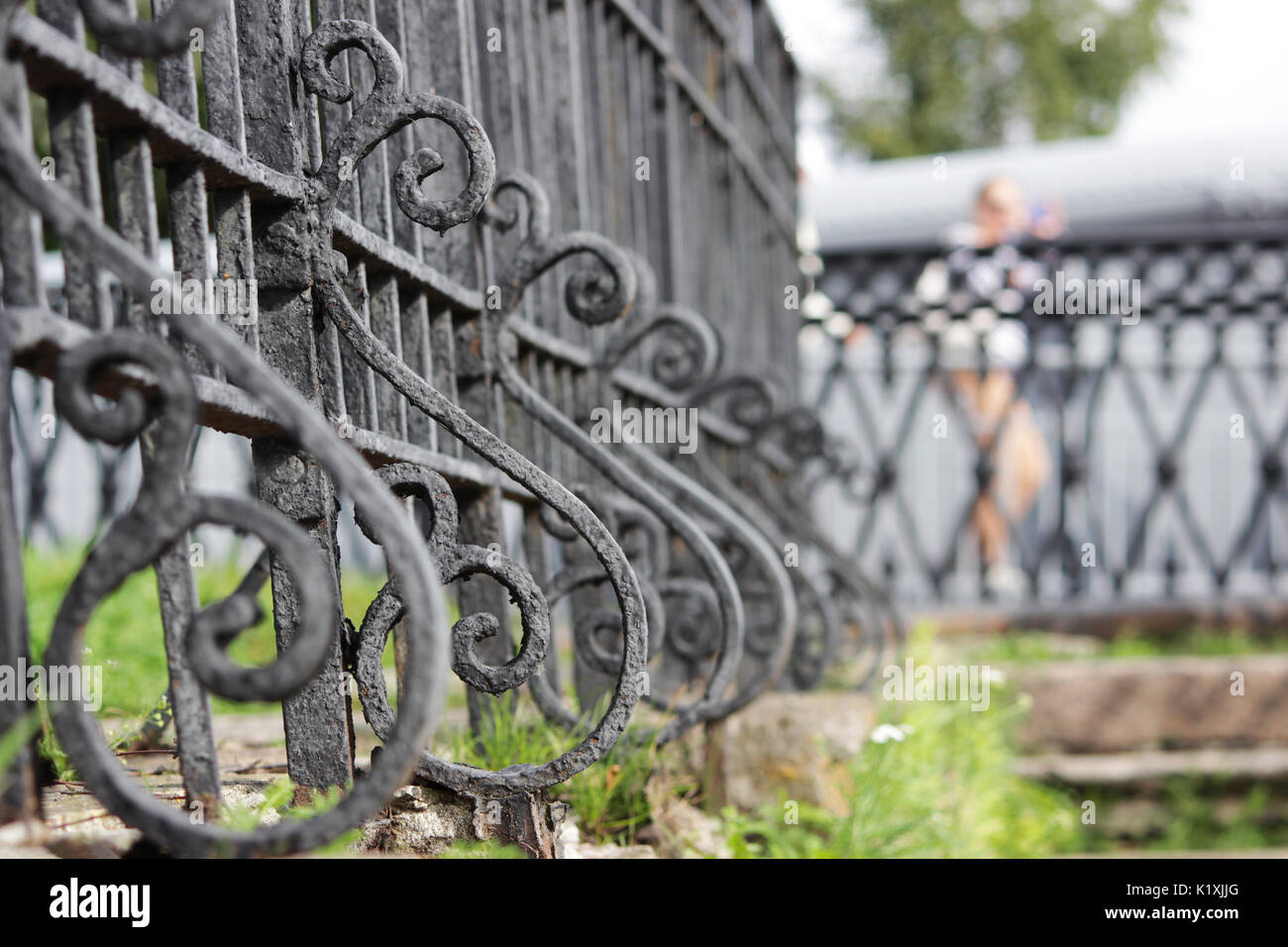 Metal historical bridge with openwork ornaments, painted gray paint ...