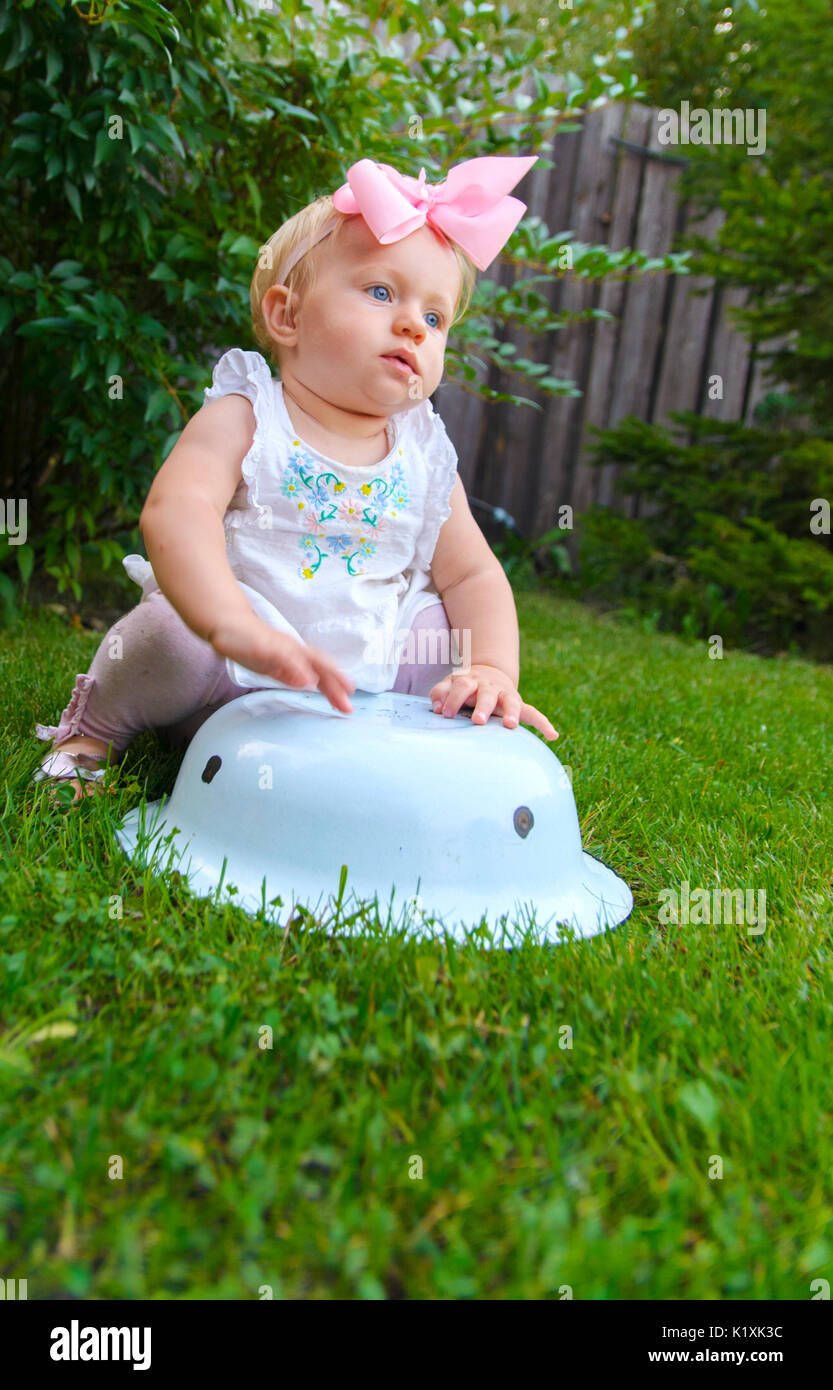 The first steps of a small child in nature on the green grass. August ...