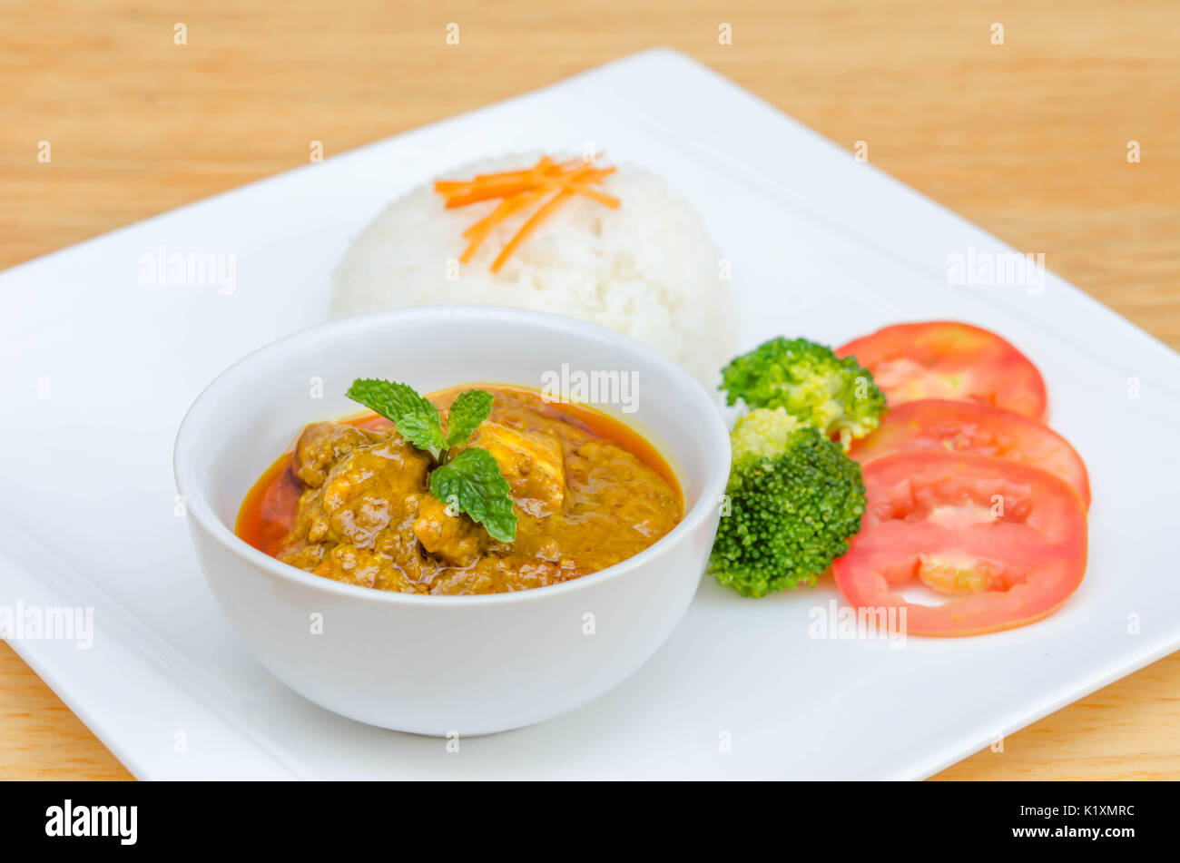 chicken tikka masala served with rice and vegetables Stock Photo - Alamy