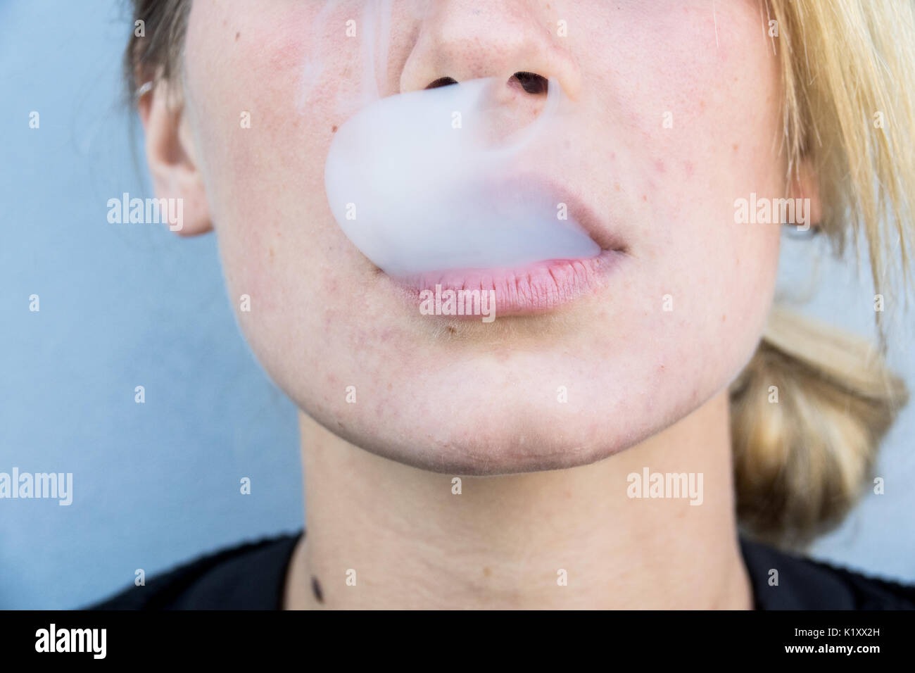 Face girl closeup, smoke from her mouth / Smoke out her mouth gently ...