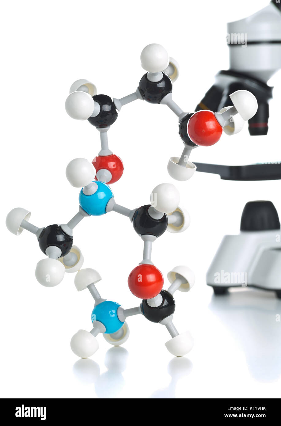 Microscope with molecule model over white background Stock Photo - Alamy