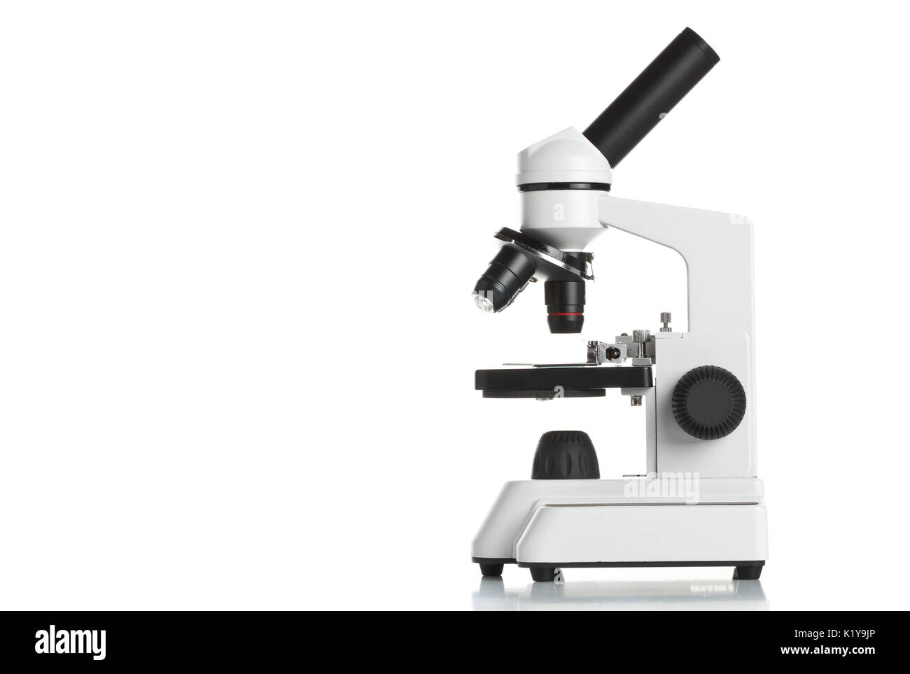 White microscope on table over white background Stock Photo - Alamy