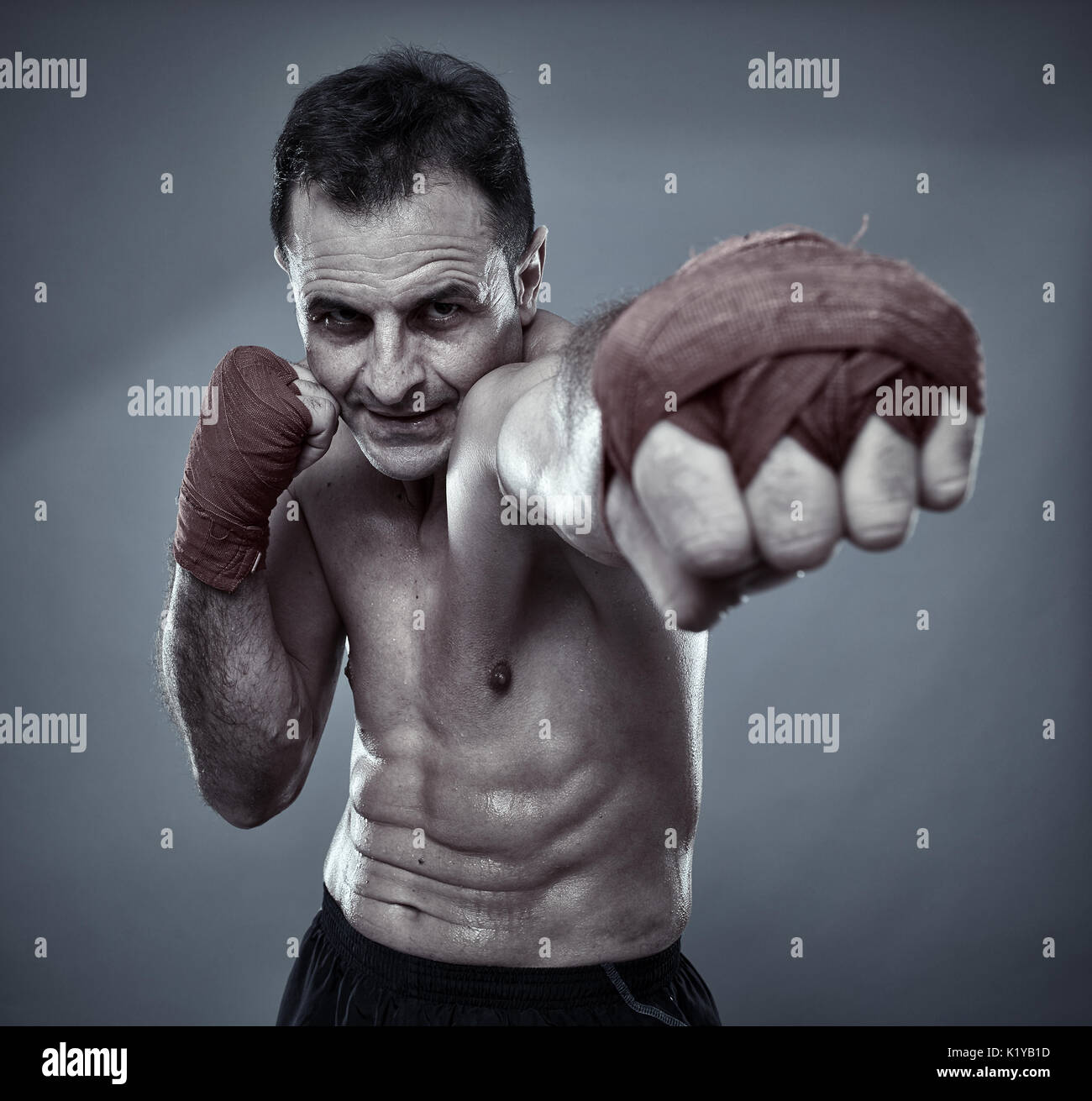 Muay thai fighter with hands wrapped shadow boxing Stock Photo - Alamy