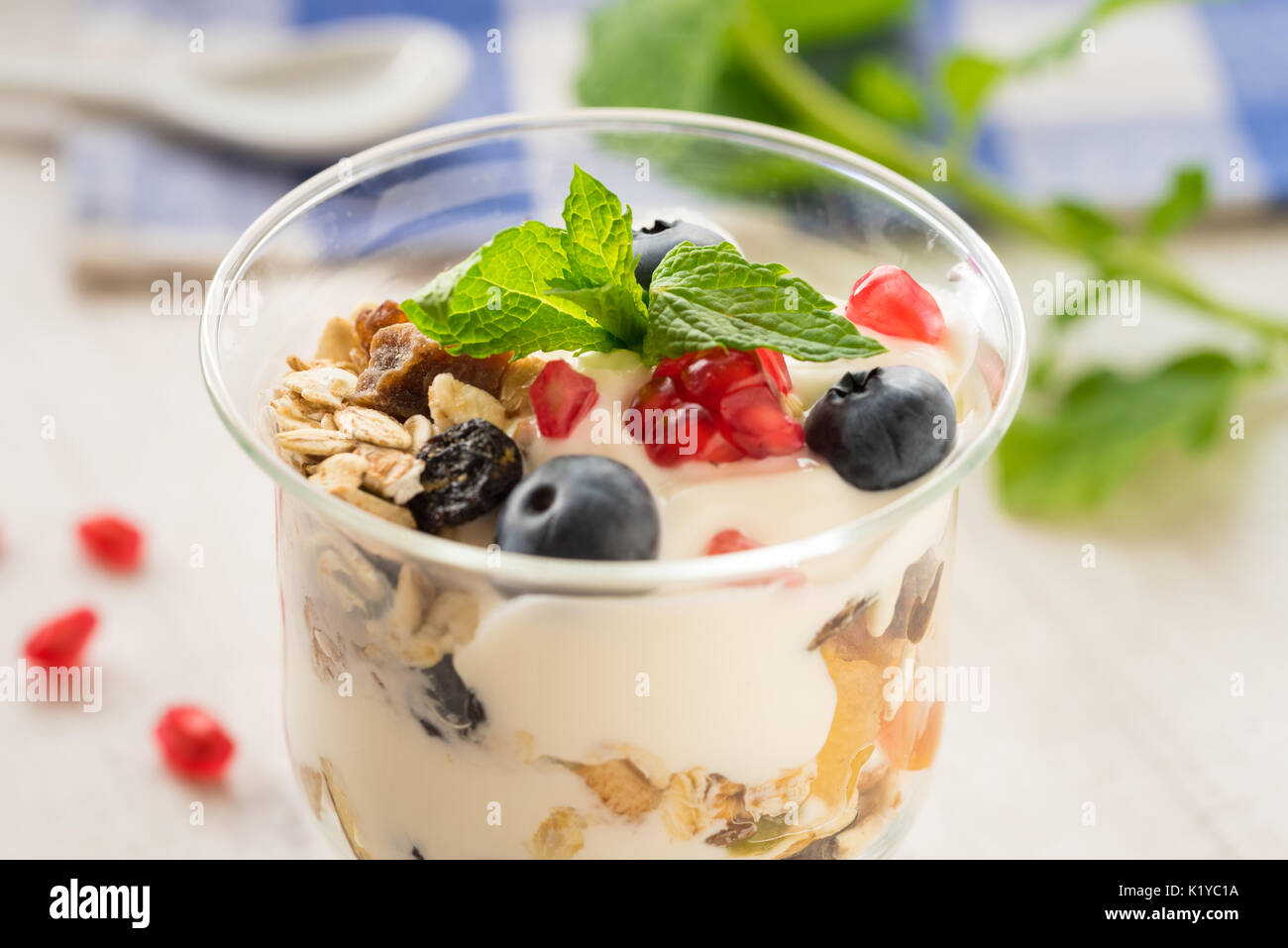 Cup of breakfast healthy muesli with blueberries, seeds of pomegranate ...