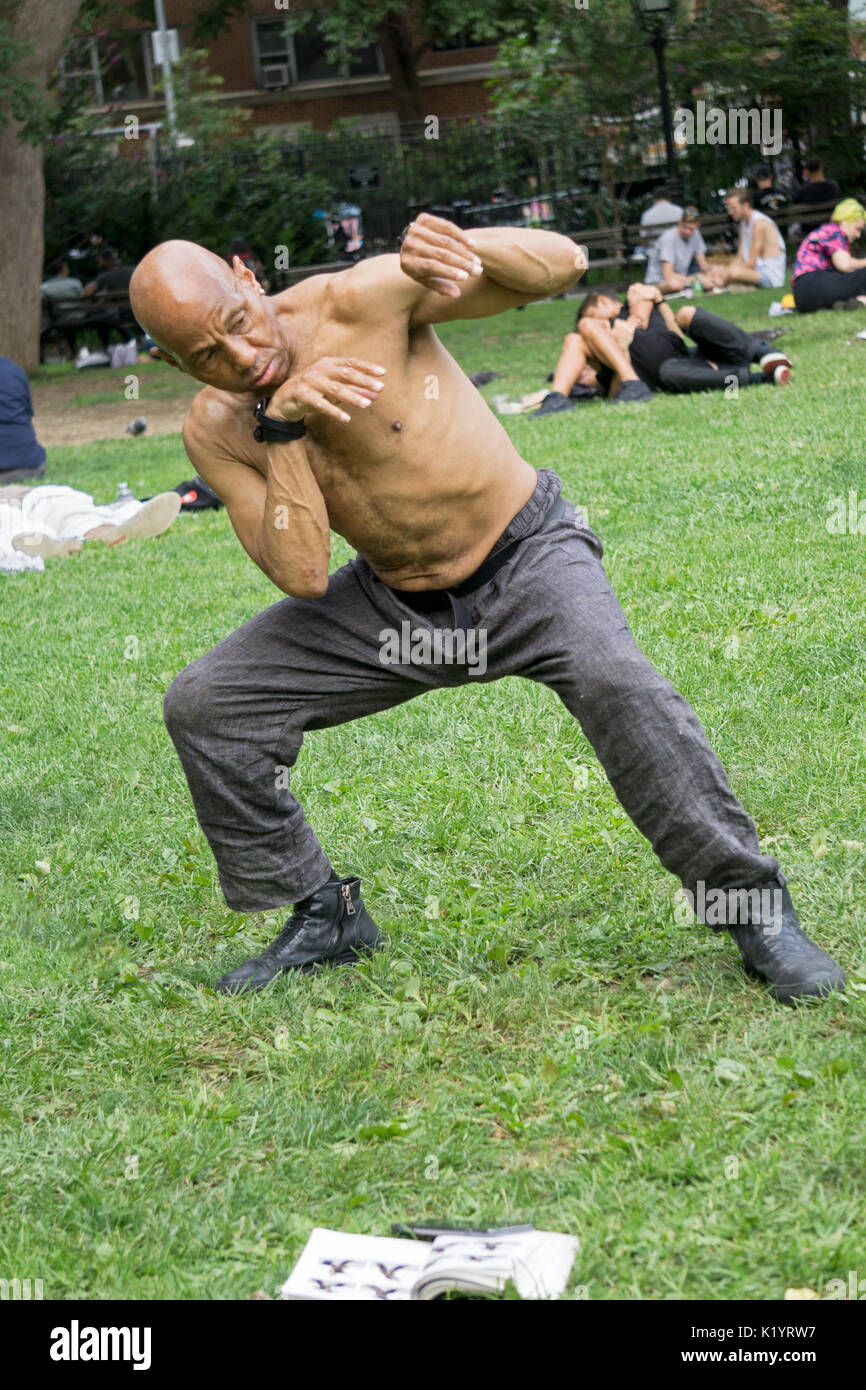 A fit shirtless 67 year old man practices kung fu moves outdoors in ...
