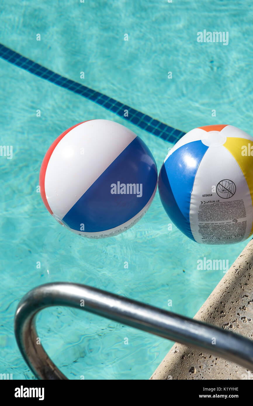 colored beachball floating in a beautiful crystal clear blue swimming ...