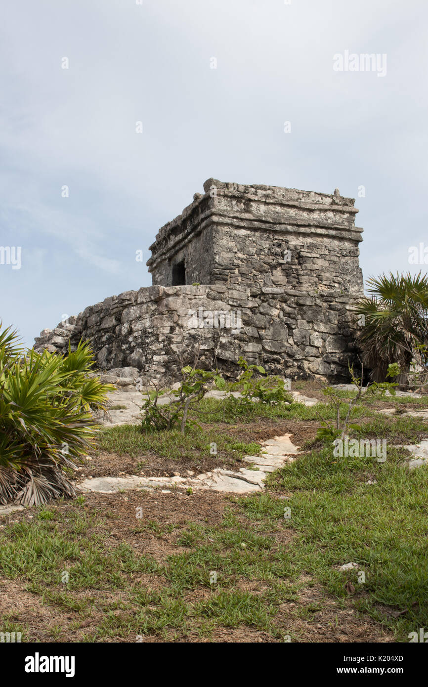 Beautiful cliff top Mayan ruins of Tulum with tropical trees and green ...