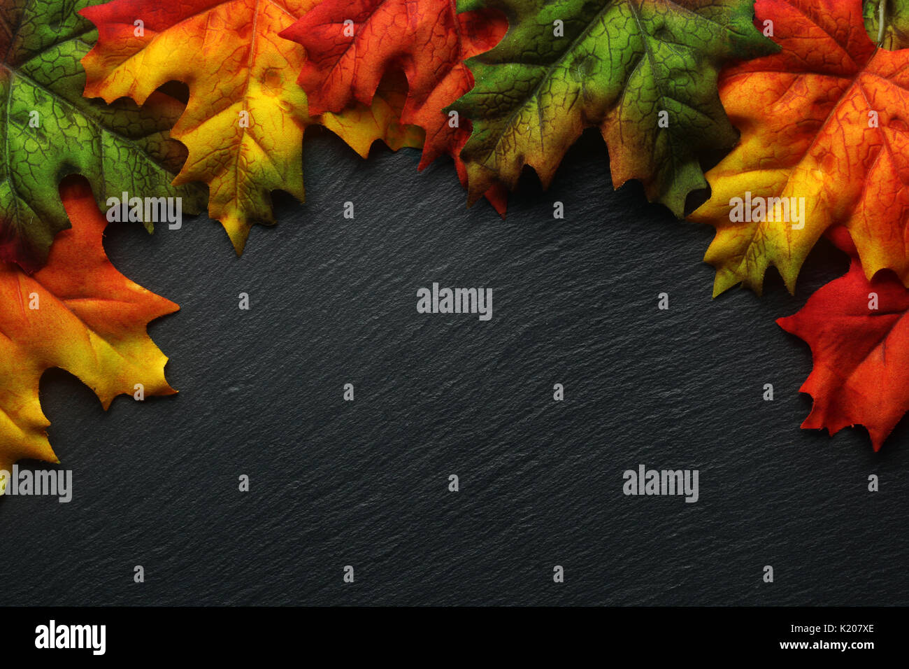 Autumn leaves on a dark slate background Stock Photo - Alamy