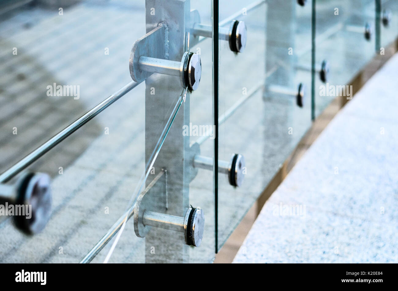 Closeup Modern glass fence with broken glass panel at the junction of ...