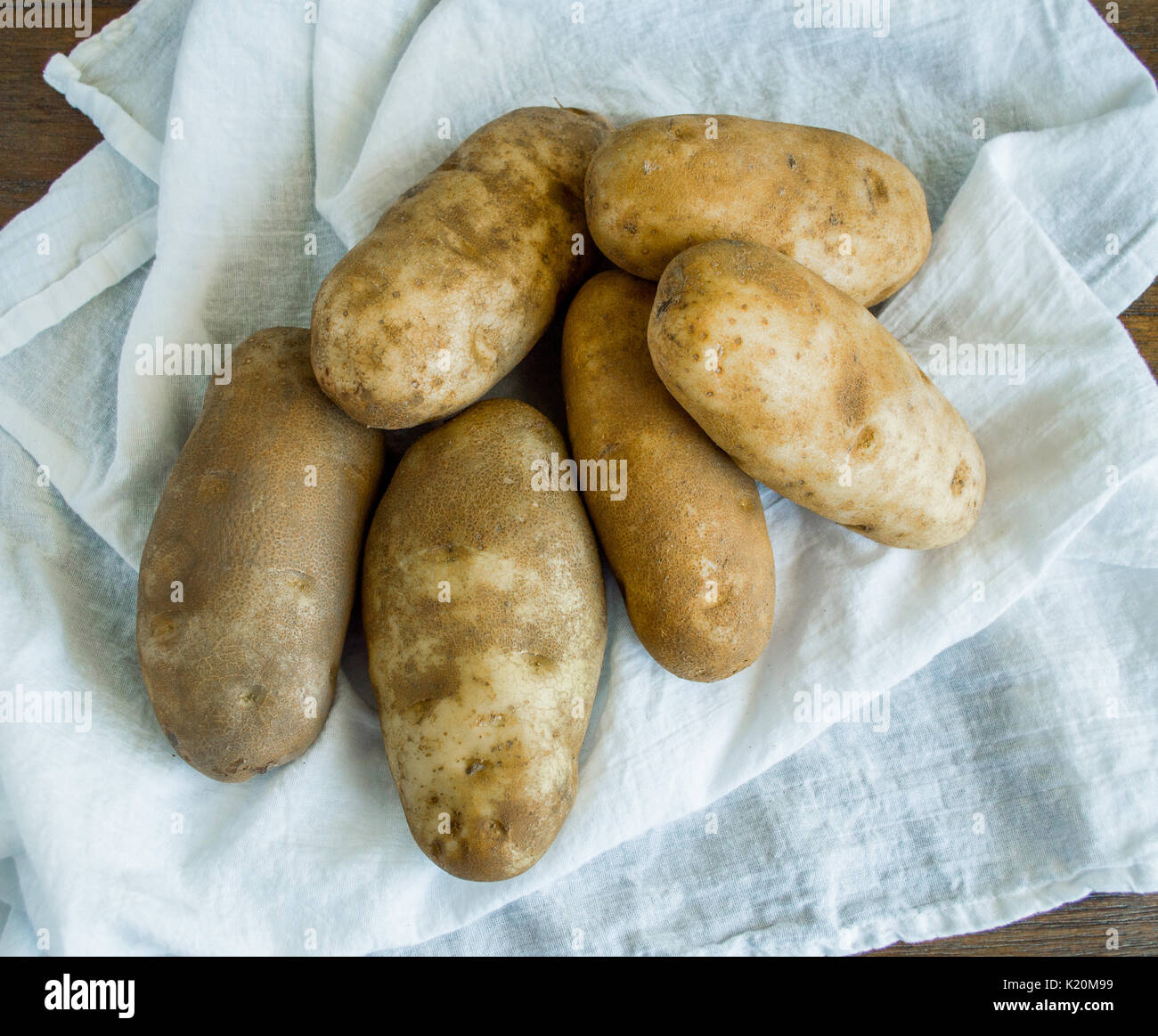still life 6 potatoes piled on a white cloth viewed from above Stock ...