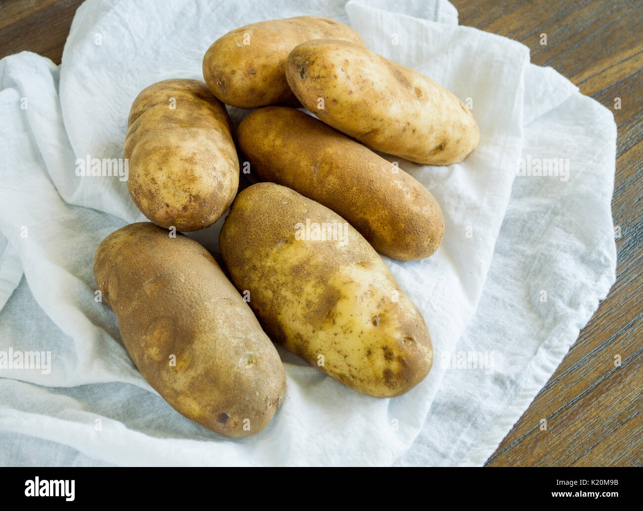 still life 6 potatoes piled on a white cloth viewed from above Stock ...