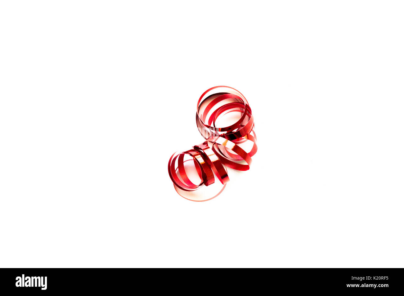 shiny red curling ribbon isolated on white Stock Photo - Alamy