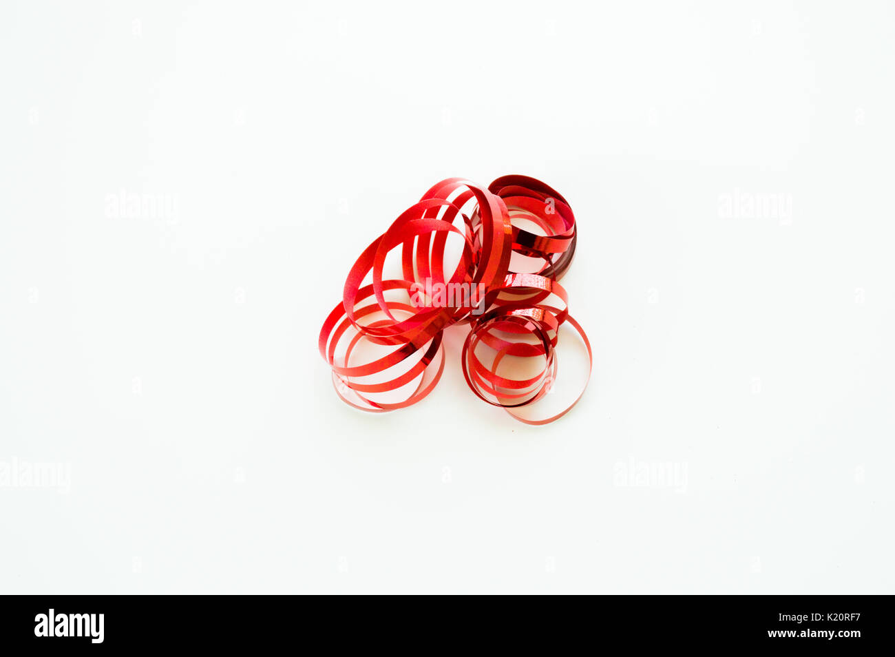 shiny red curling ribbon isolated on white Stock Photo - Alamy