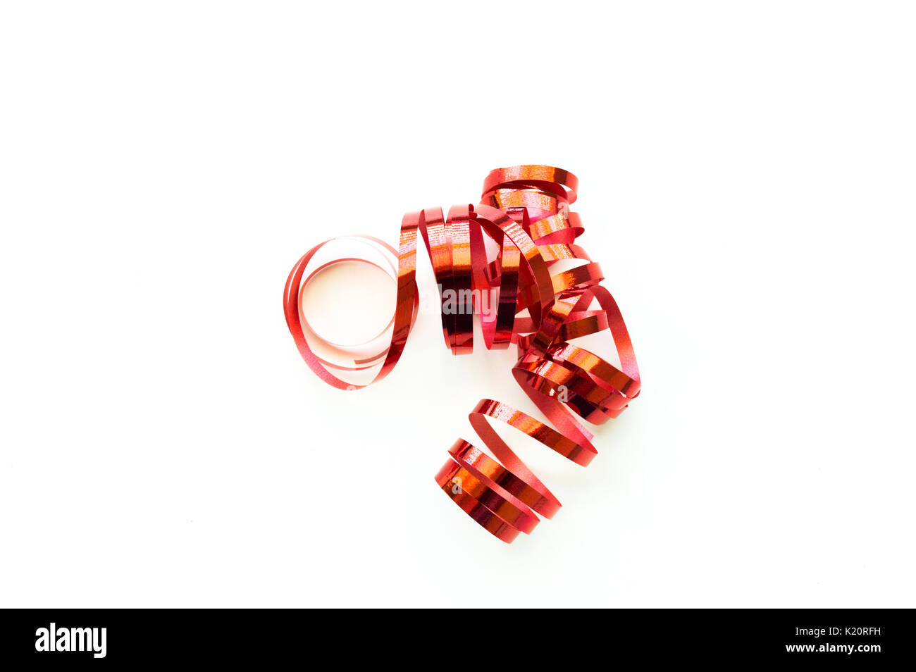 shiny red curling ribbon isolated on white Stock Photo - Alamy