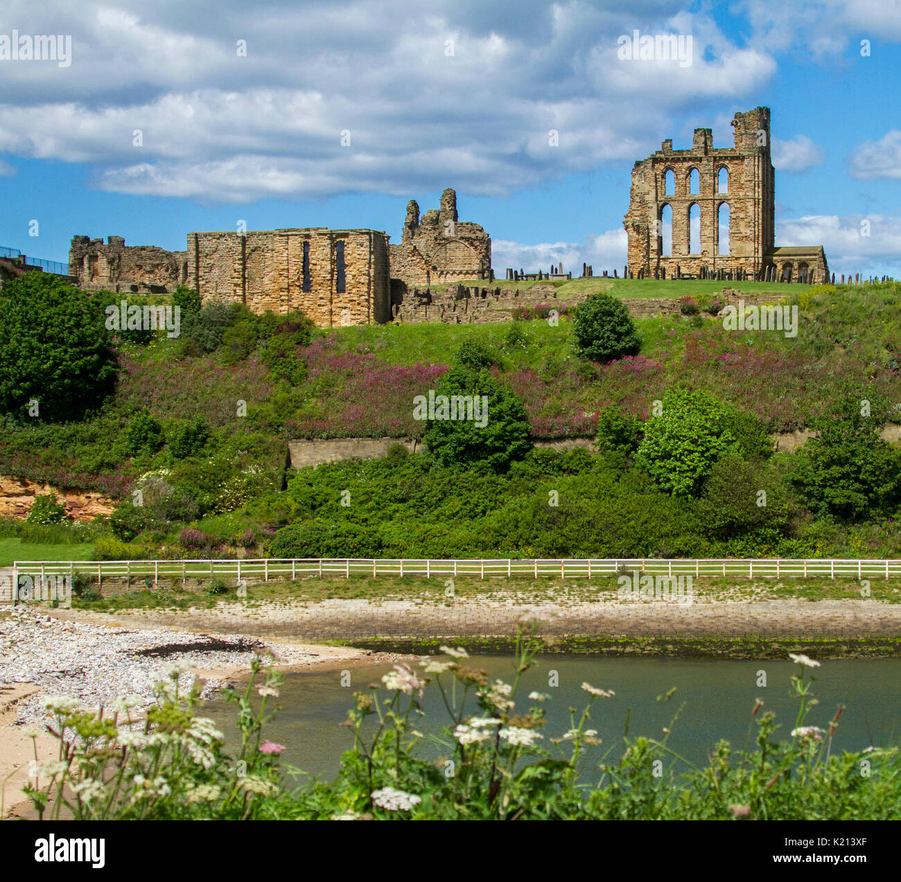 Ruins of historic hilltop Tynemouth castle and priory with ocean and ...