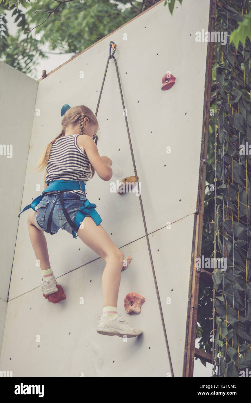 little girl climbing a rock wall outdoor. Concept of sport life Stock ...