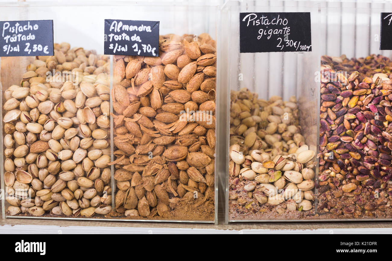 pile of almonds and pistachios in plastic containers selling in food ...