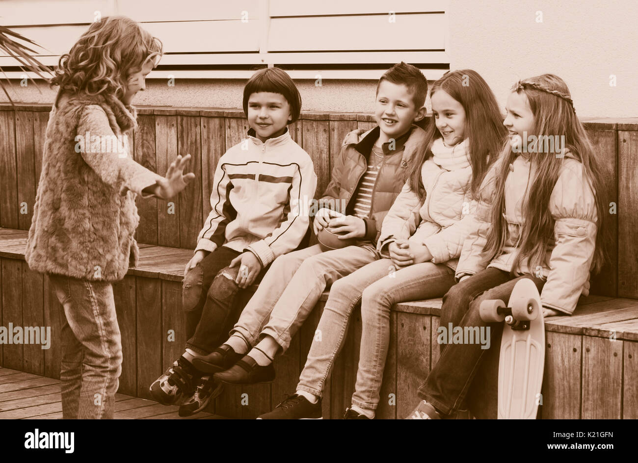 Little kid acting out phrase to friends during charade outdoor Stock ...