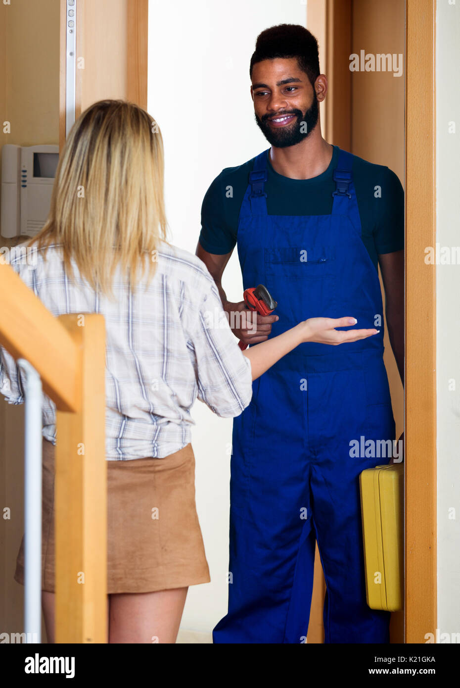Friendly handyman visiting female client to help at home Stock Photo ...