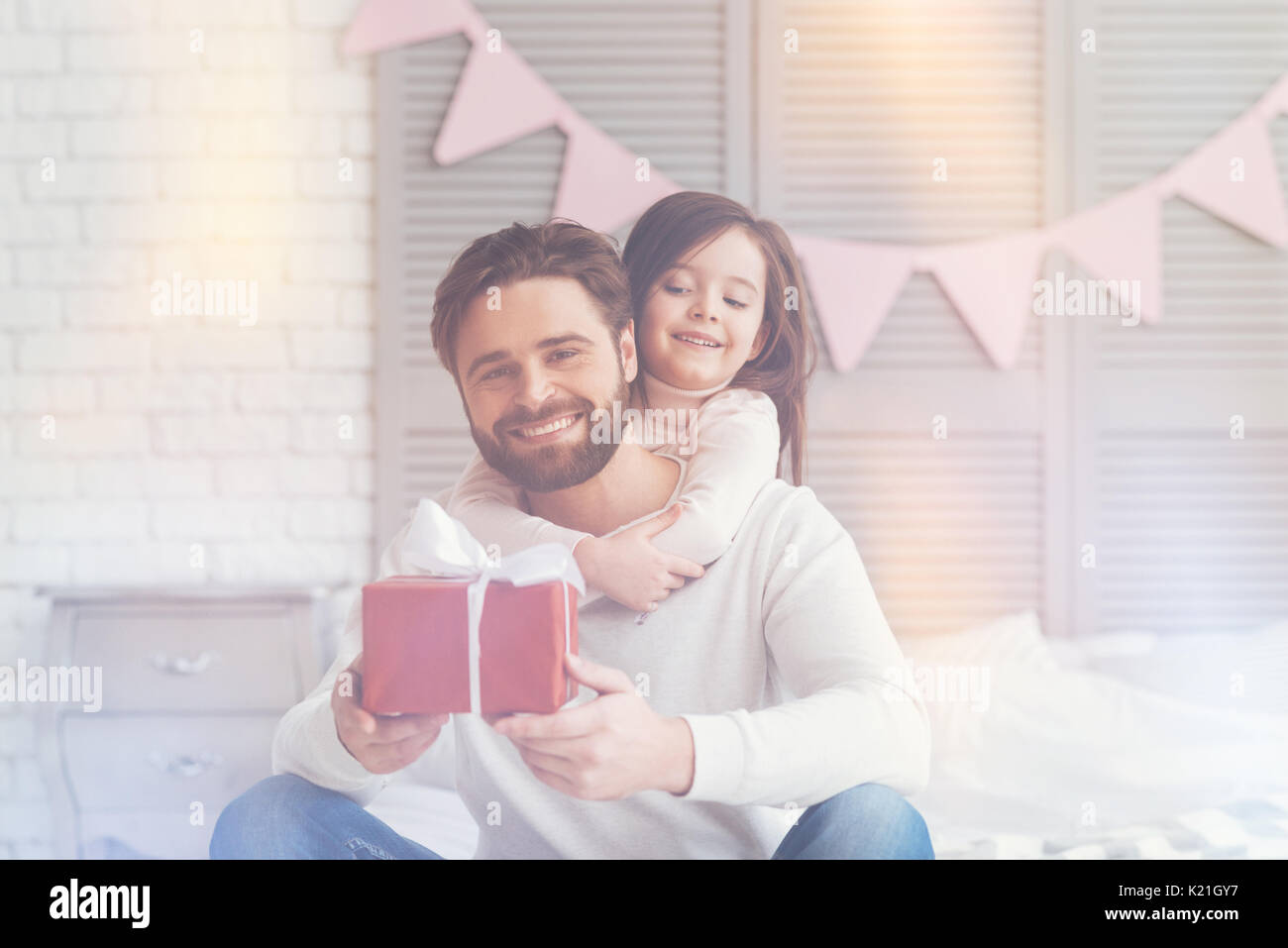Enthusiastic vibrant family having a present ready Stock Photo - Alamy