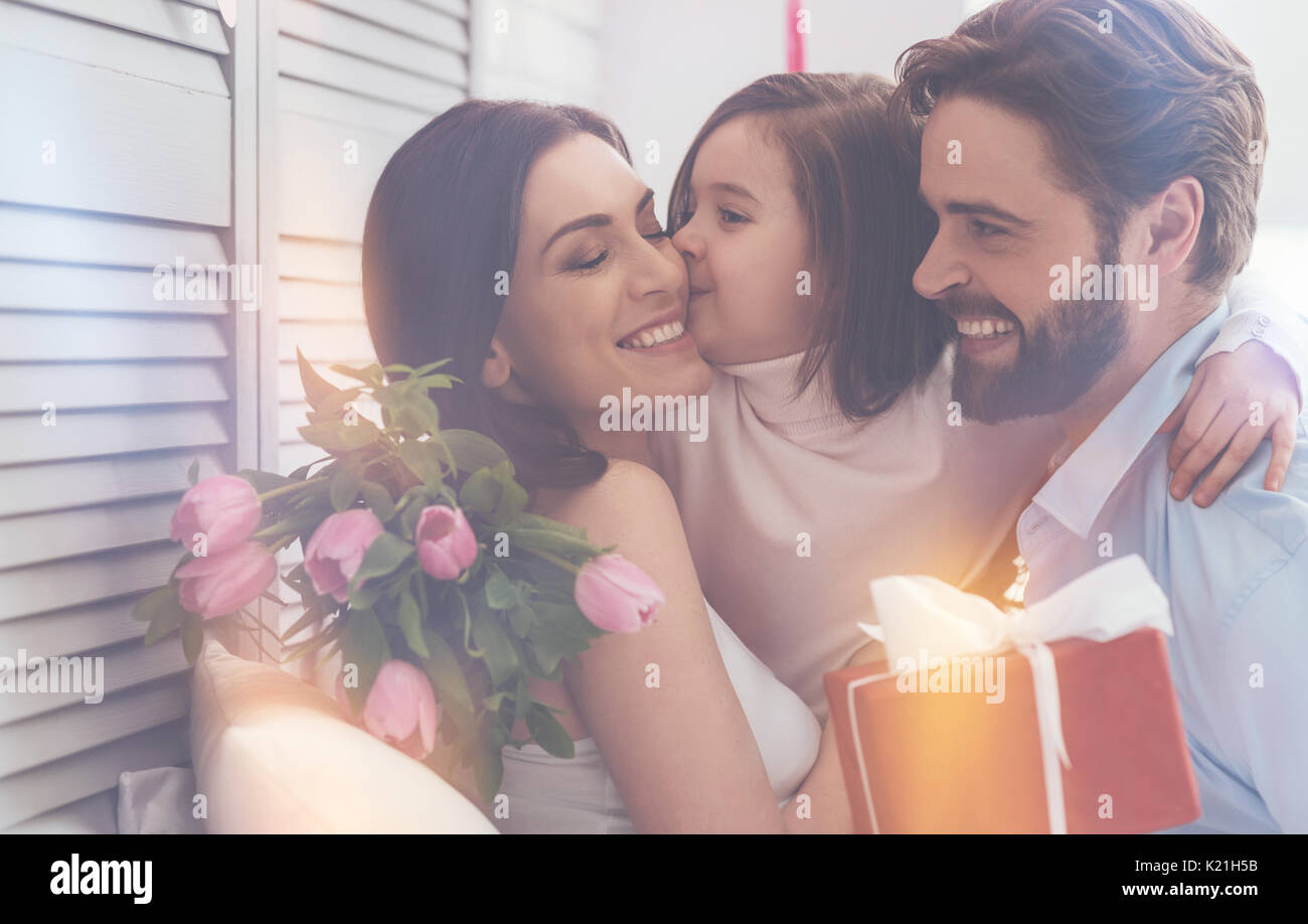 Wonderful family making their mom feeling happy Stock Photo - Alamy
