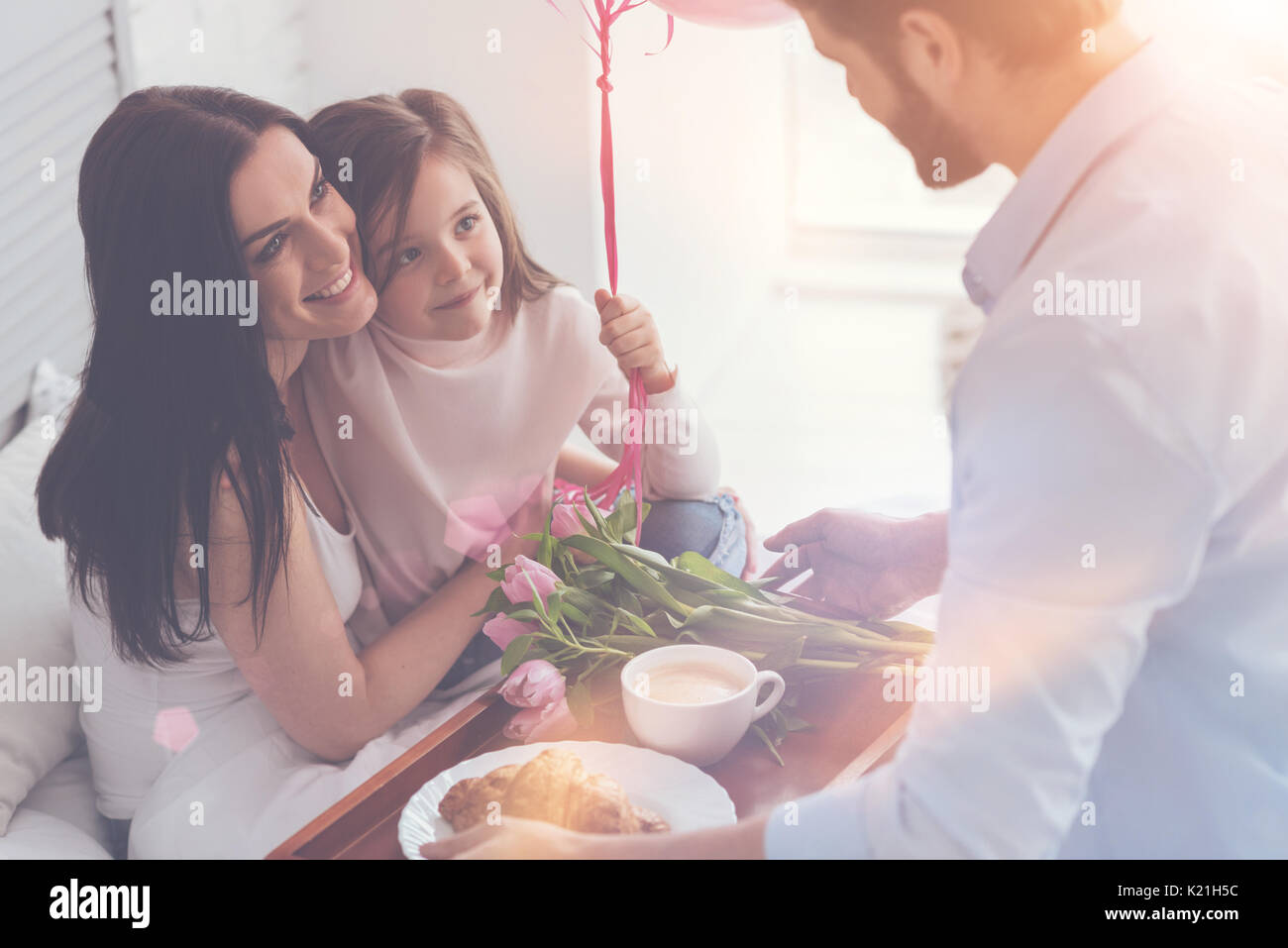 Adorable young family making their mom feeling special Stock Photo - Alamy