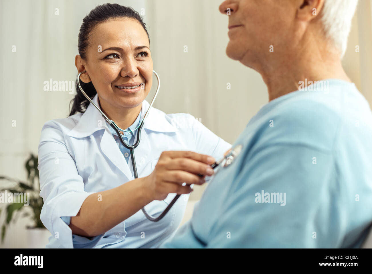 Joyful nice doctor doing medical examination Stock Photo - Alamy
