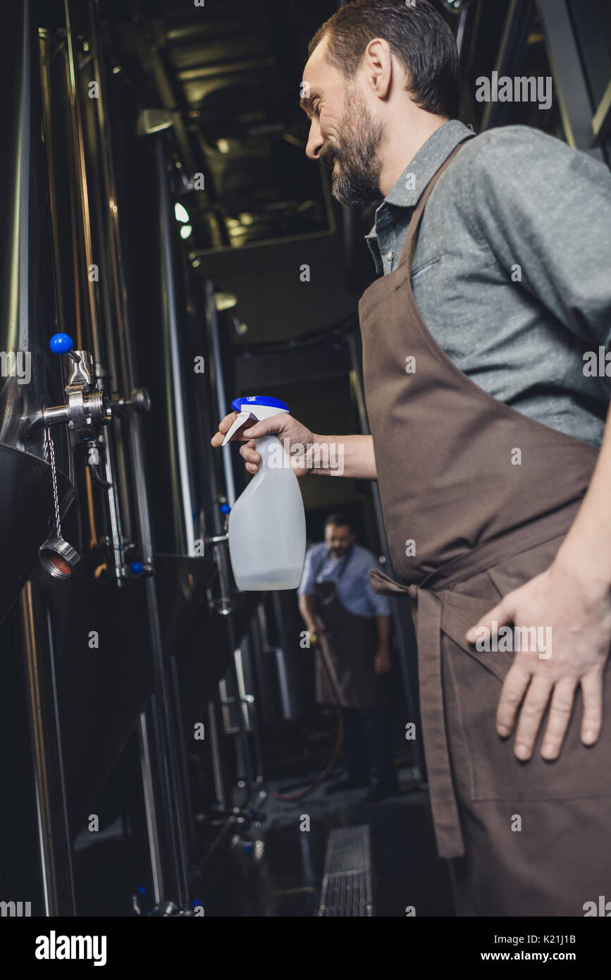 Male brewery worker spraying brewery tank Stock Photo - Alamy