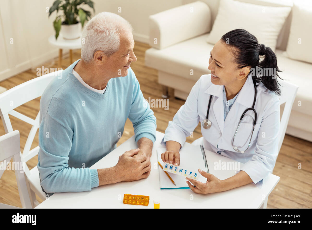 Cheerful smart doctor prescribing medicine Stock Photo - Alamy